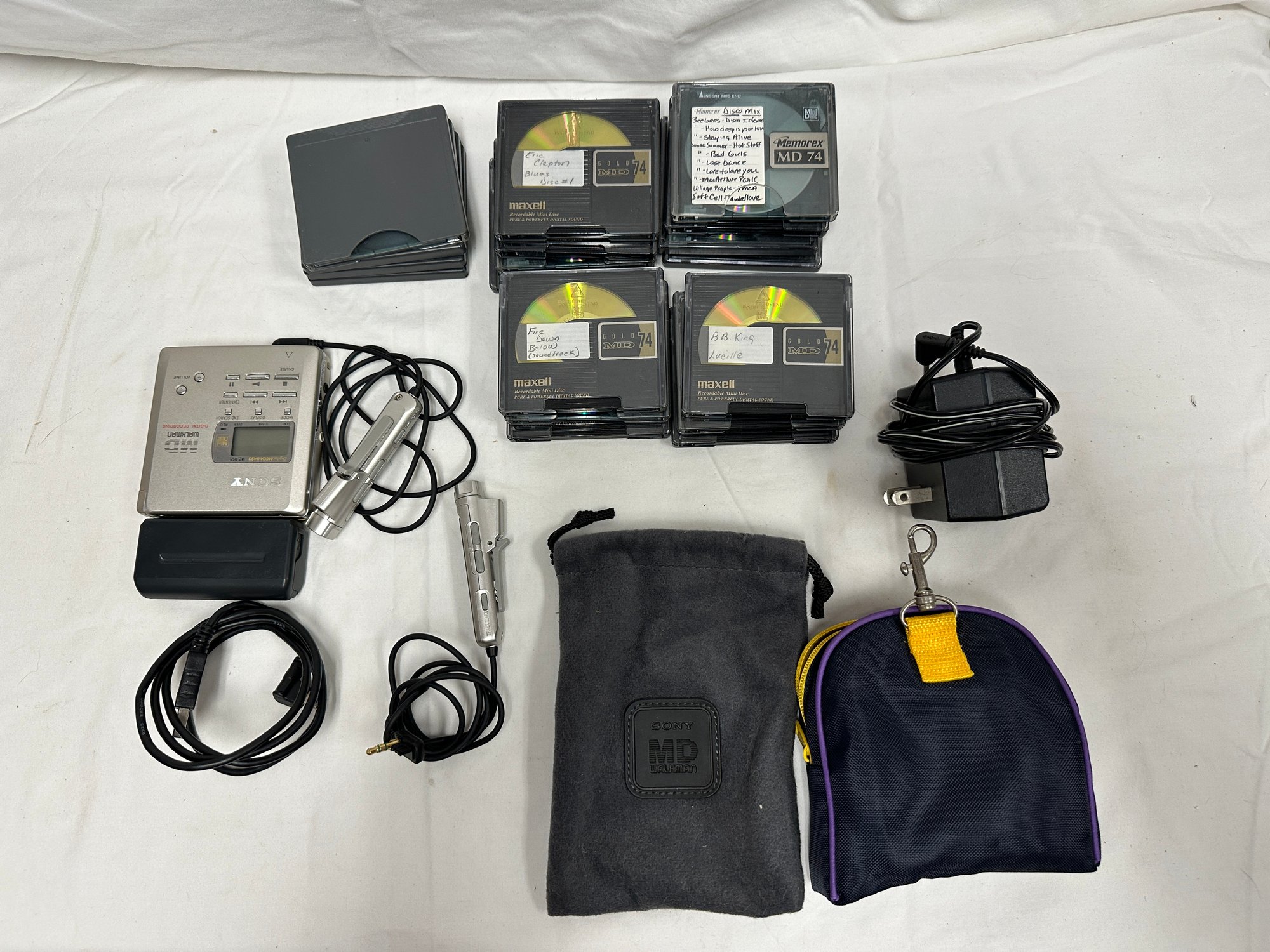 A Vintage Sony Walkman And Mini Disks #1922921 | Auctionninja.com