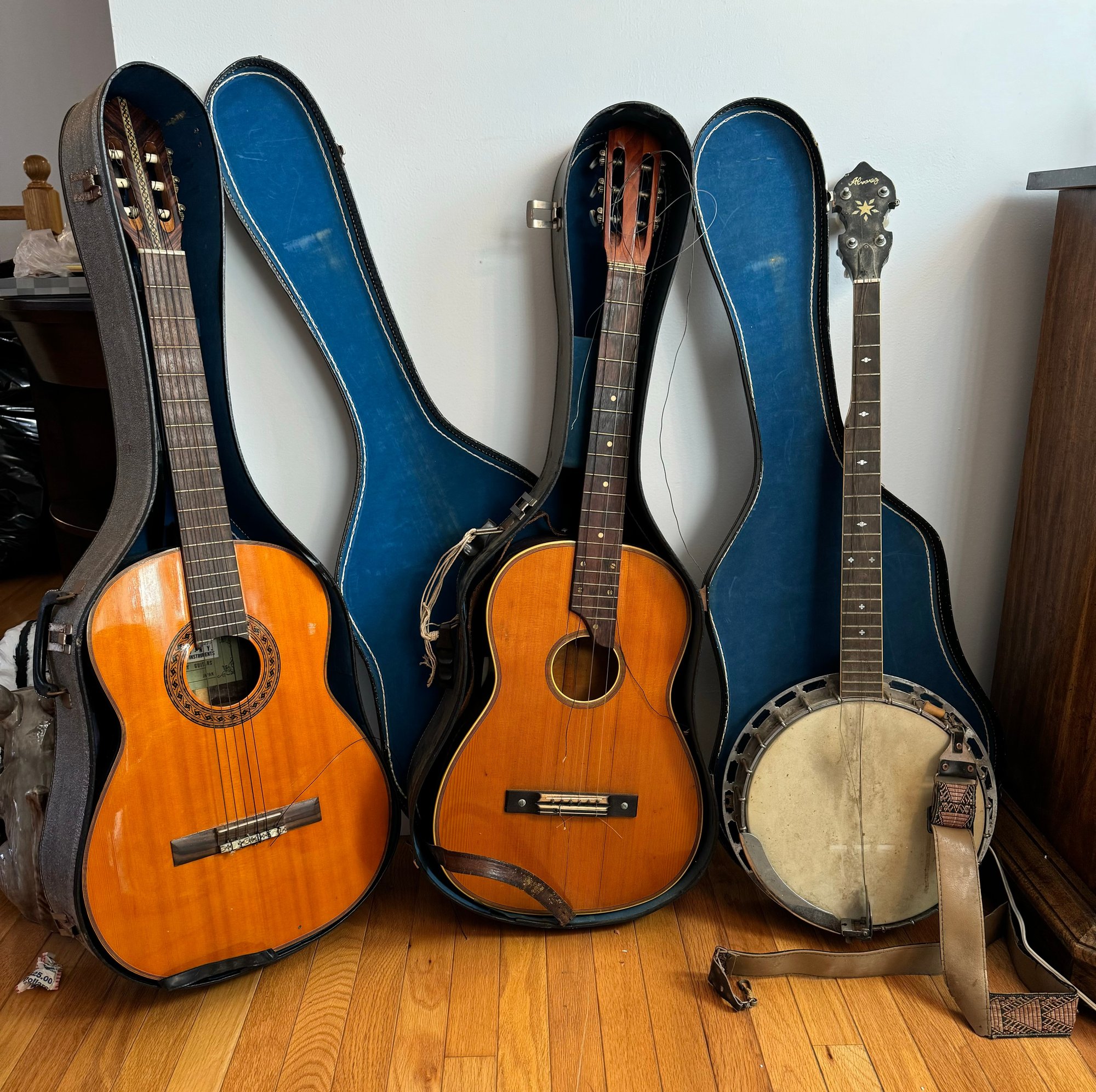 Three String Instruments Including A Banjo And Two Guitars #2229088 ...