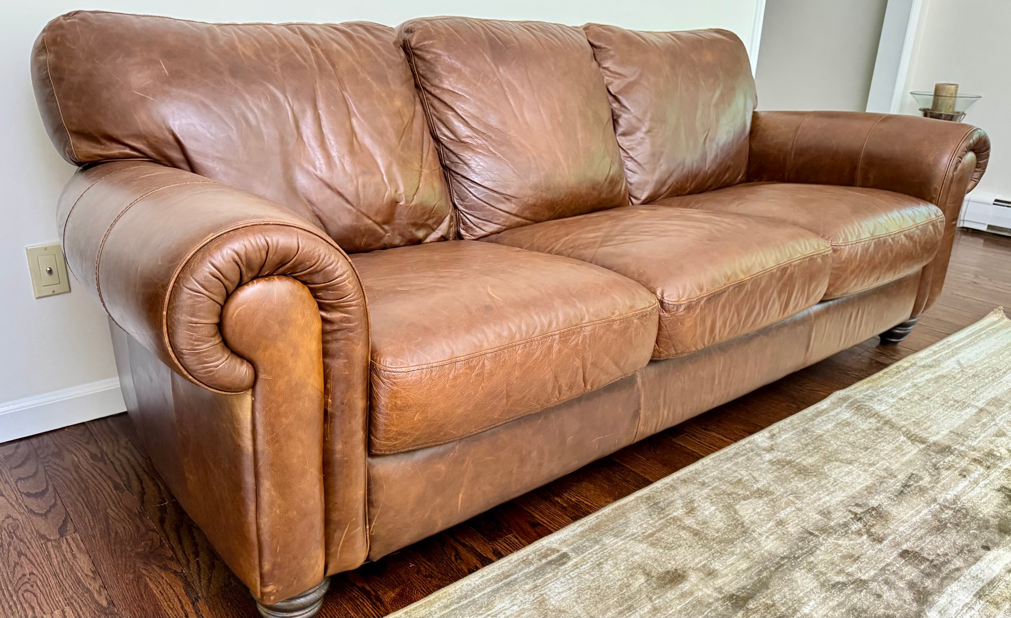 A Three Cushions Leather Couch With Scroll Arms #2124116 | Auctionninja.com