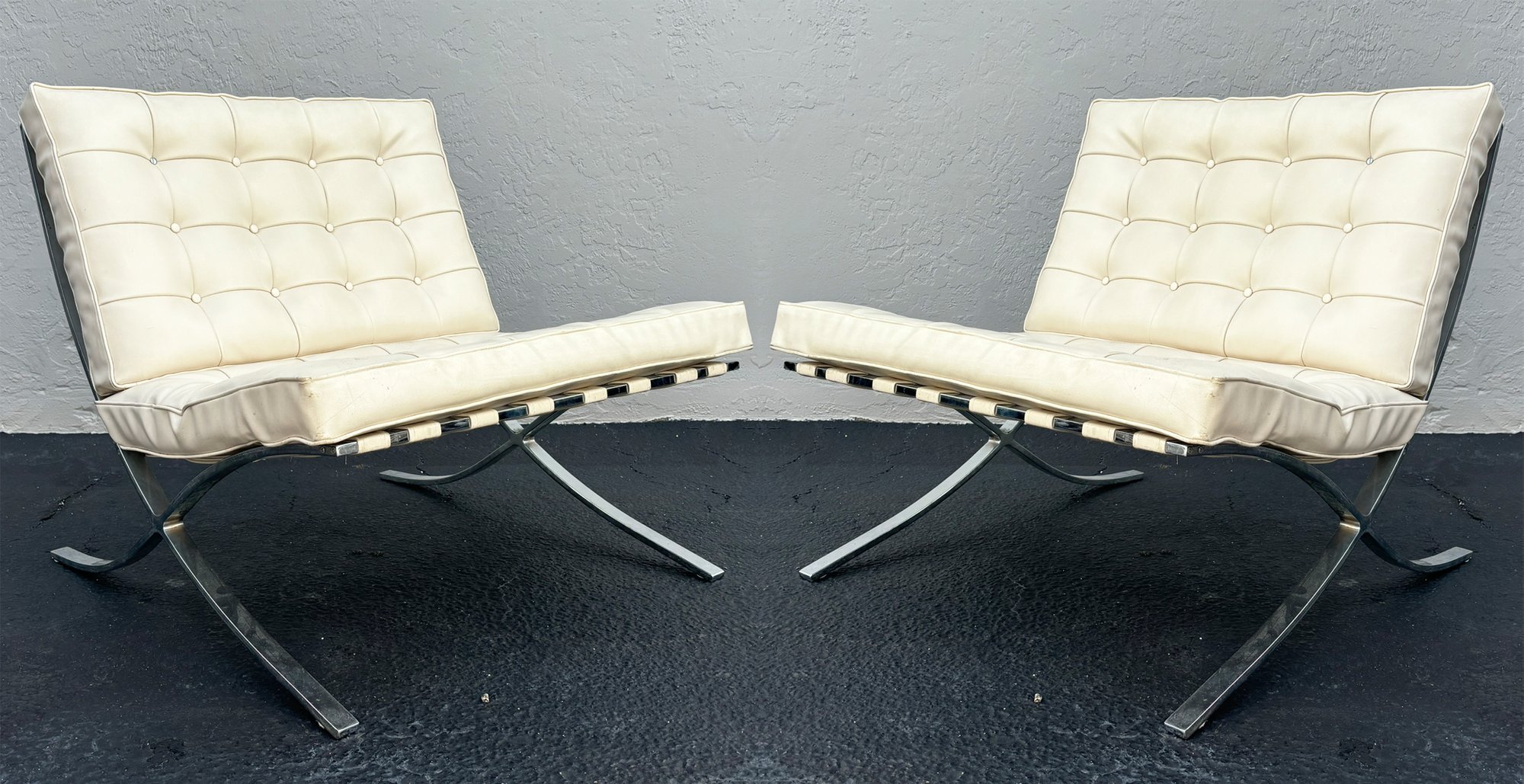 A Pair Of Vintage Barcelona Chairs In Chrome And White Leather Likely ...