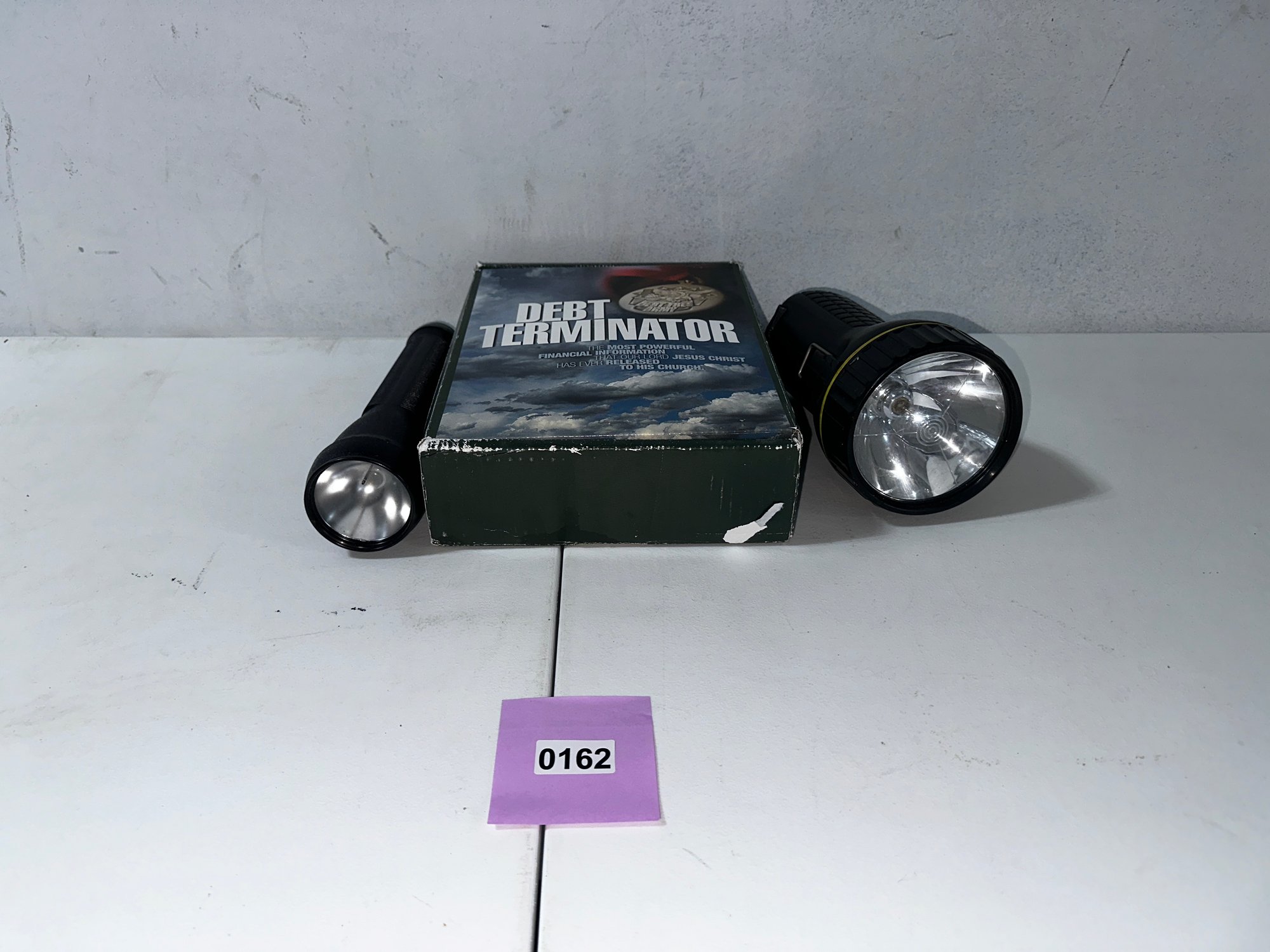 162 - DEBT TERMINATOR PROGRAM AND FLASHLIGHTS #21073 | Auctionninja.com