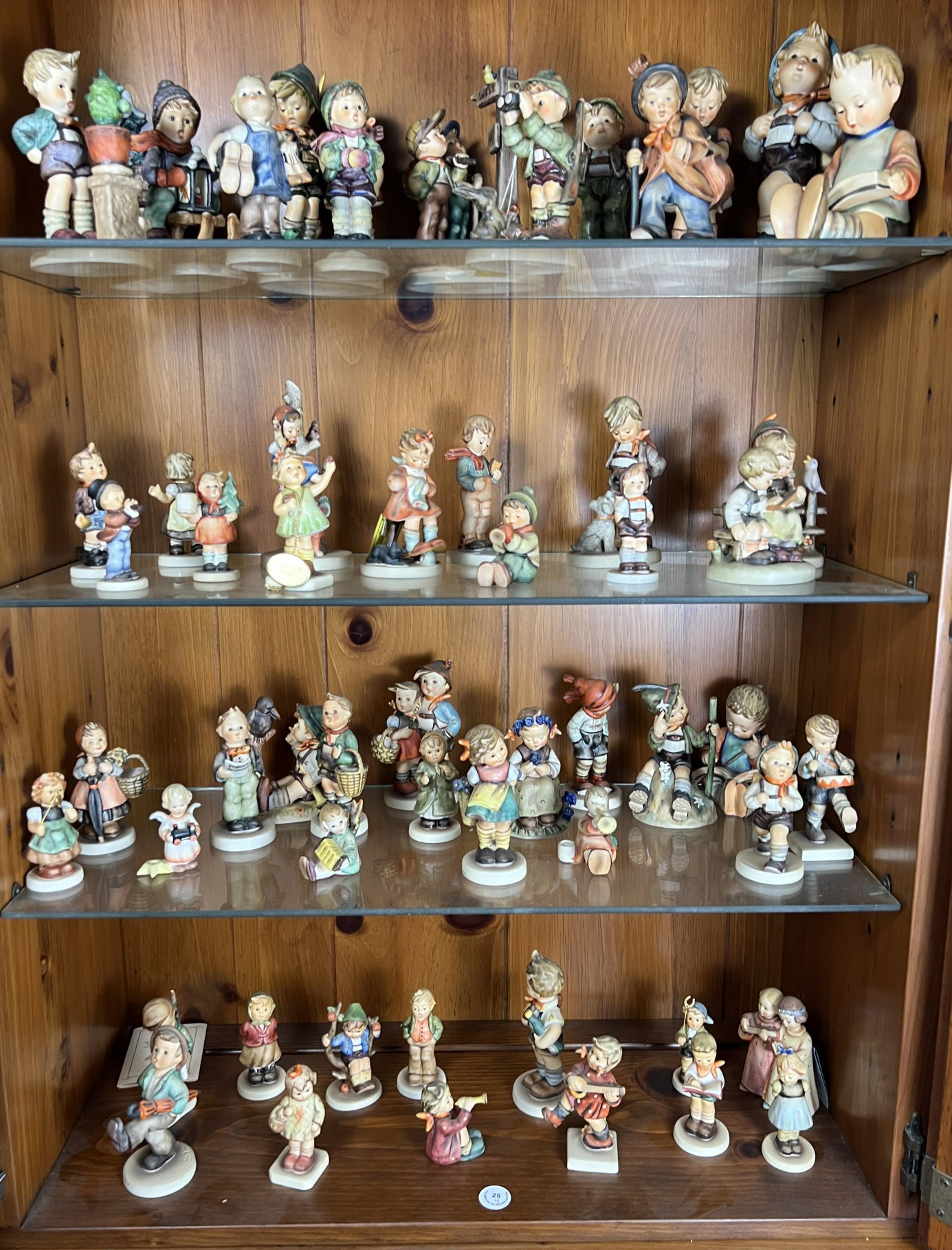 (4) SHELVES of HUMMEL FIGURINES #46875 | Auctionninja.com