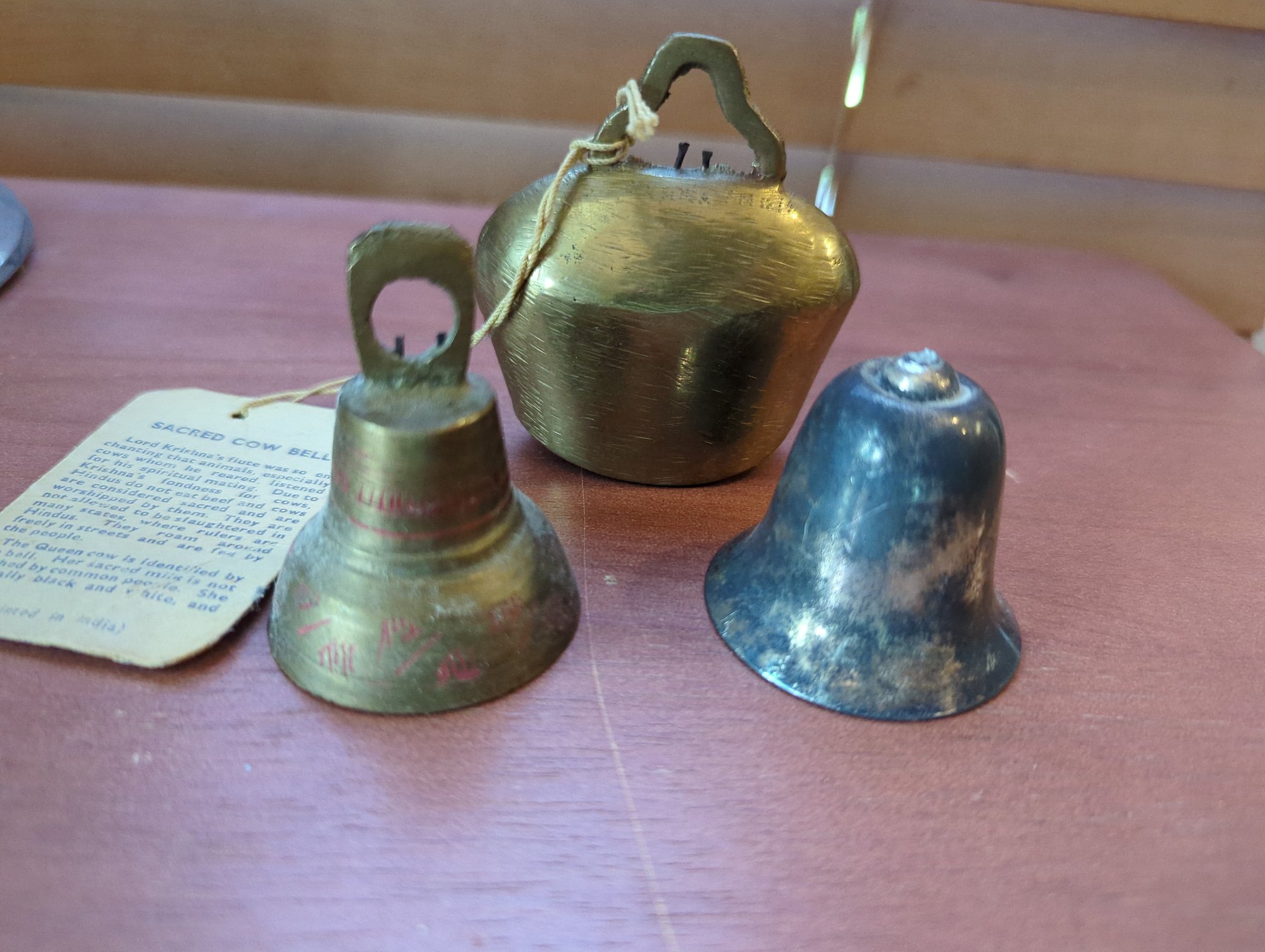 Three Small Bells. One Brass Bell With Markings. One Sacred Cowbell One ...