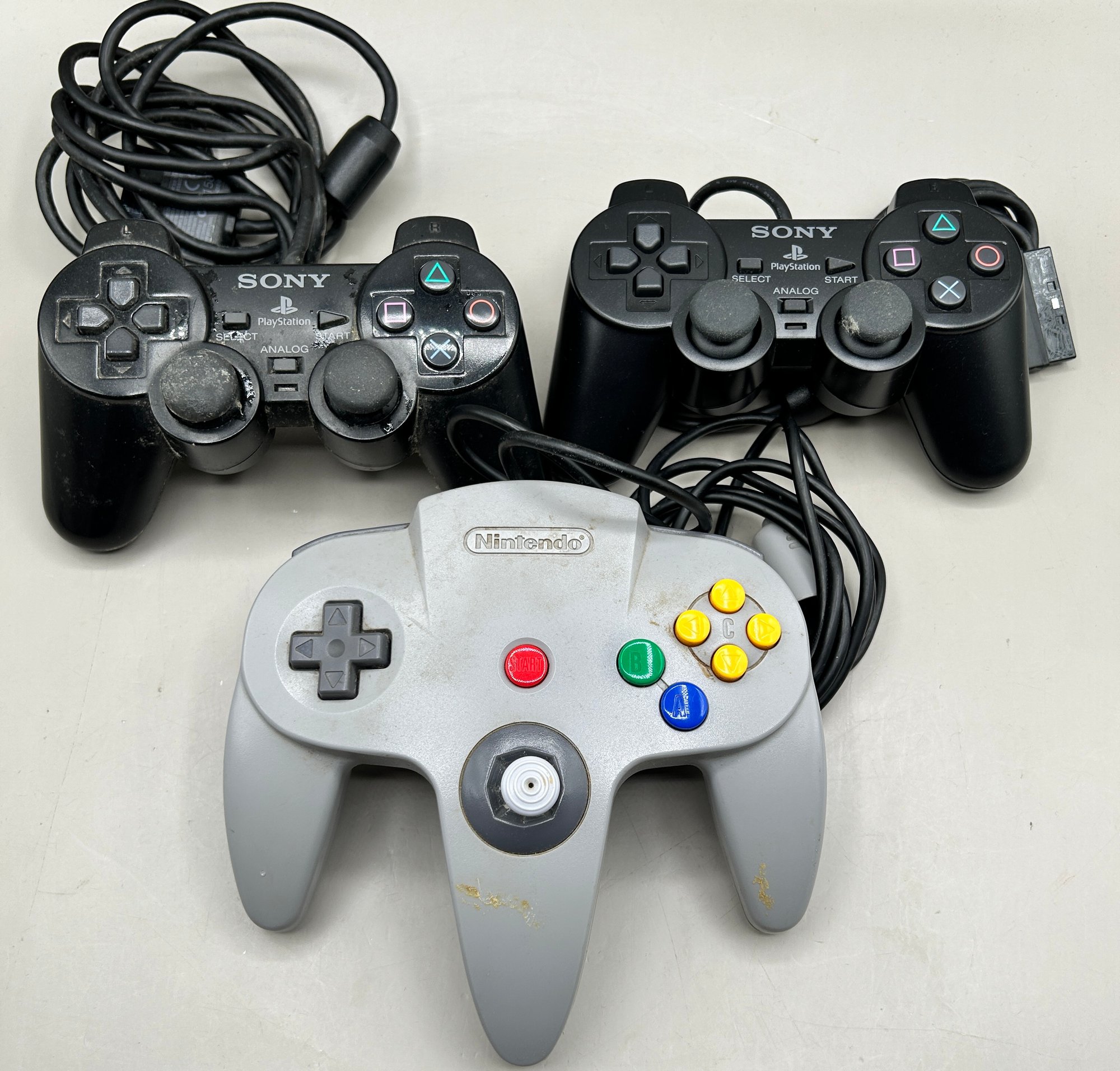 2 Sony Playstation Analog Controllers And Nintendo 64 Game Controller ...