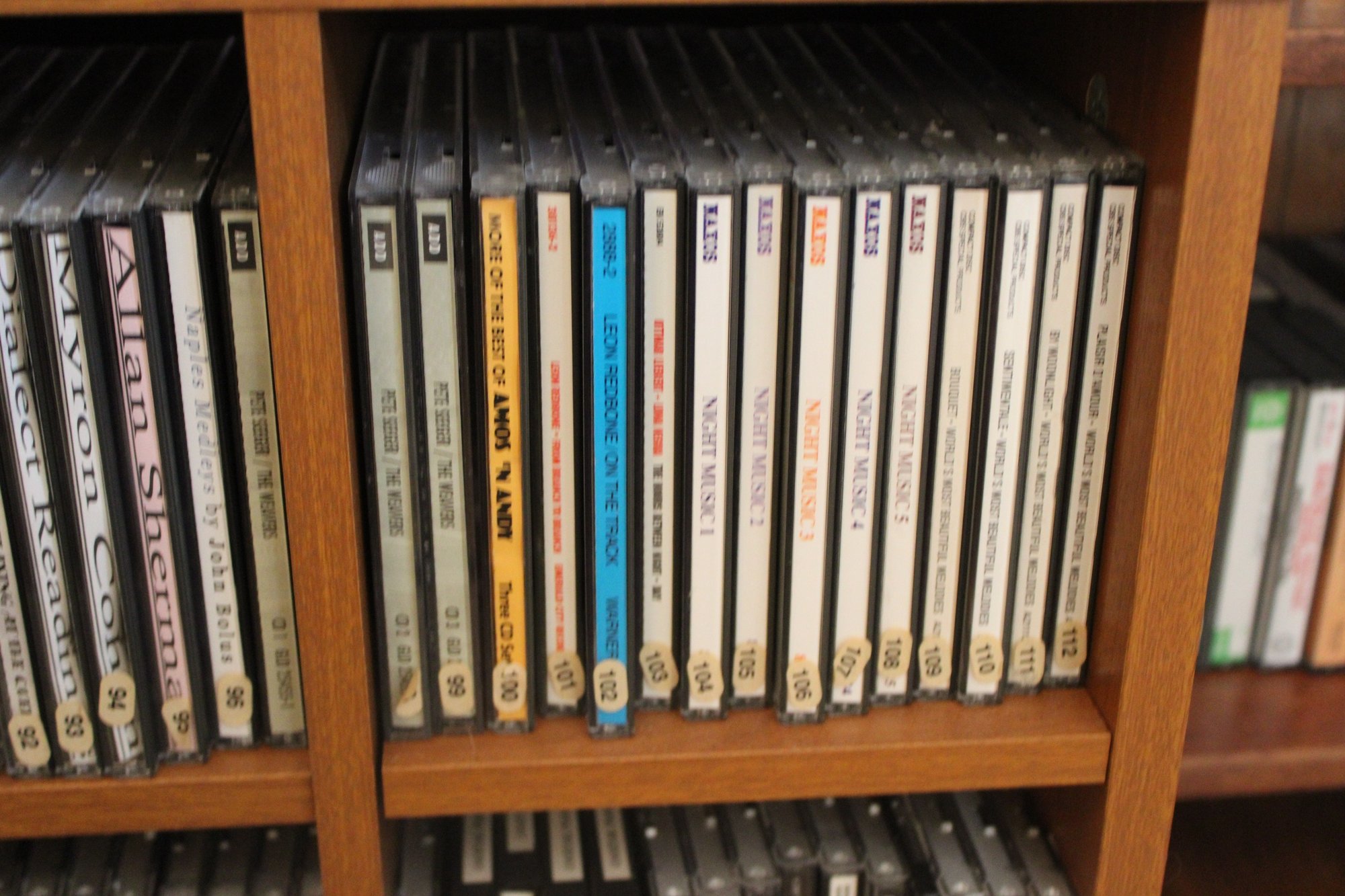 COLLECTION OF MUSIC CDS AND CASSETTES SOME AUDIO BOOKS WITH SHELVING ...